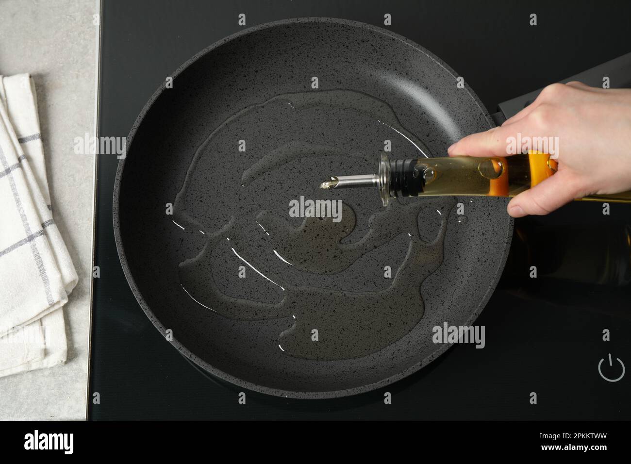 Woman pouring cooking oil from bottle into frying pan, top view Stock ...
