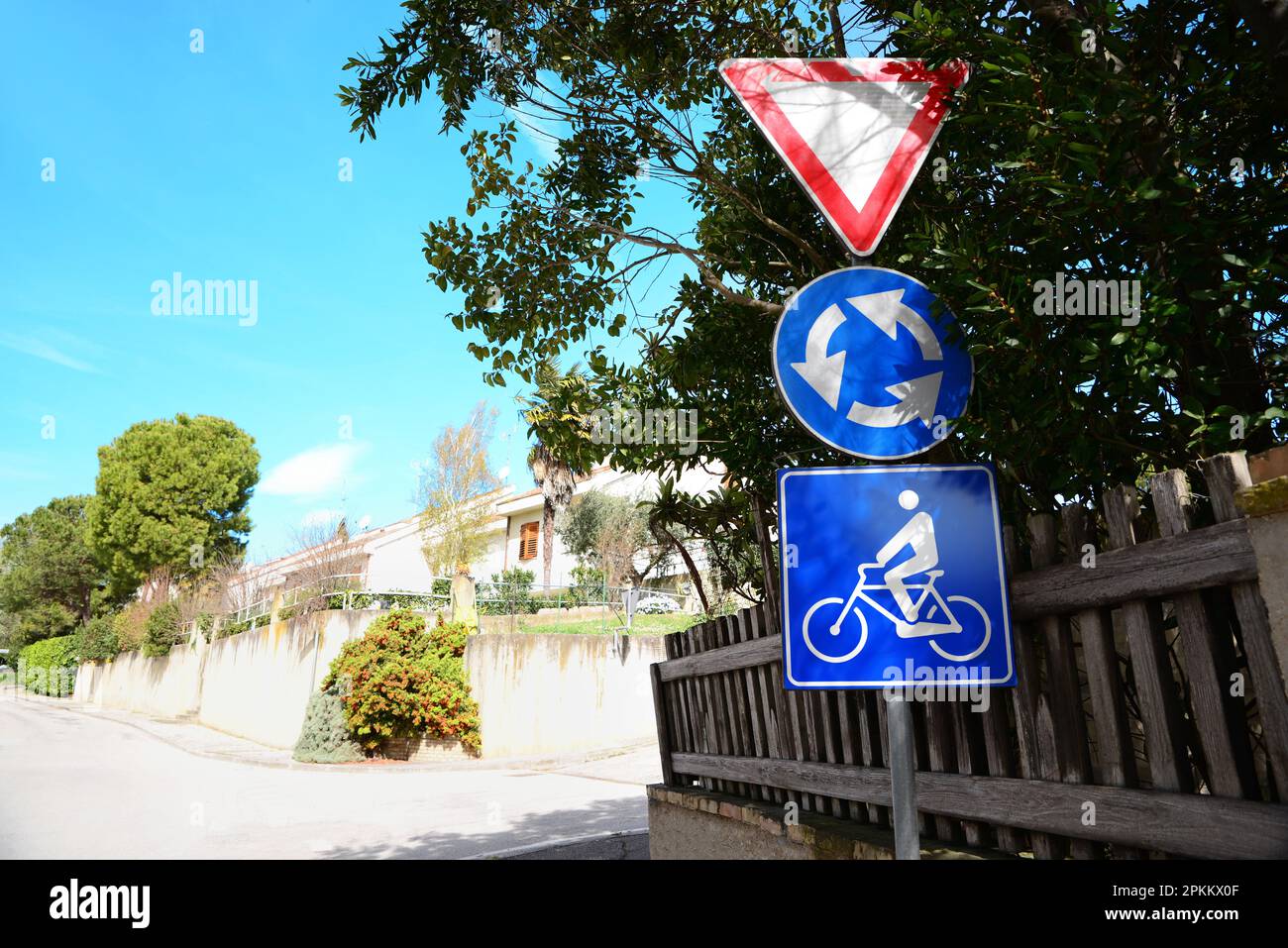 Different traffic signs on city street, space for text Stock Photo - Alamy