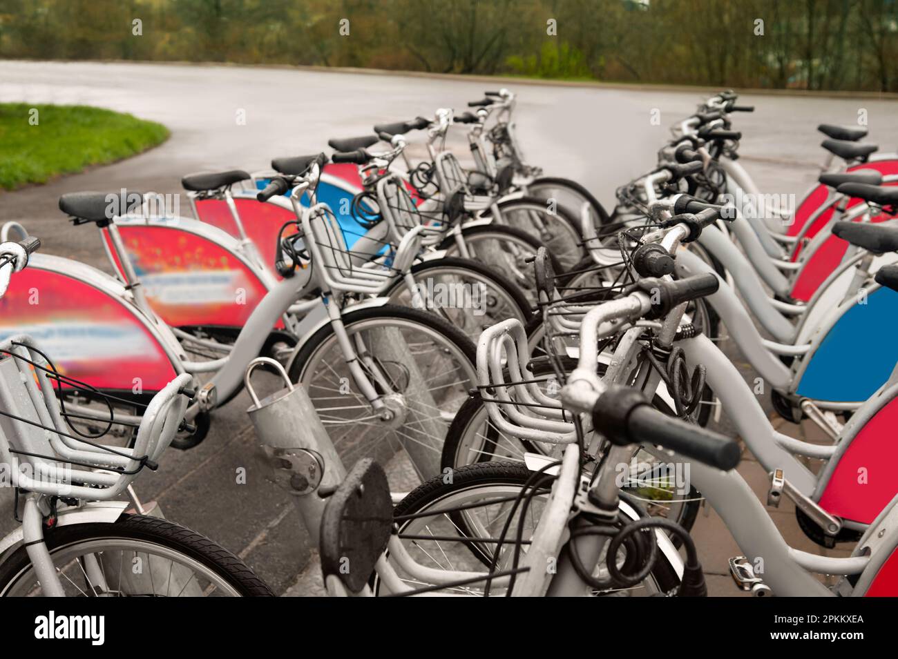 Many bicycles parked outdoors. Bike rental service Stock Photo - Alamy