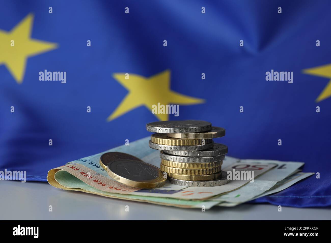Coins, banknotes and European Union flag on table, closeup Stock Photo ...