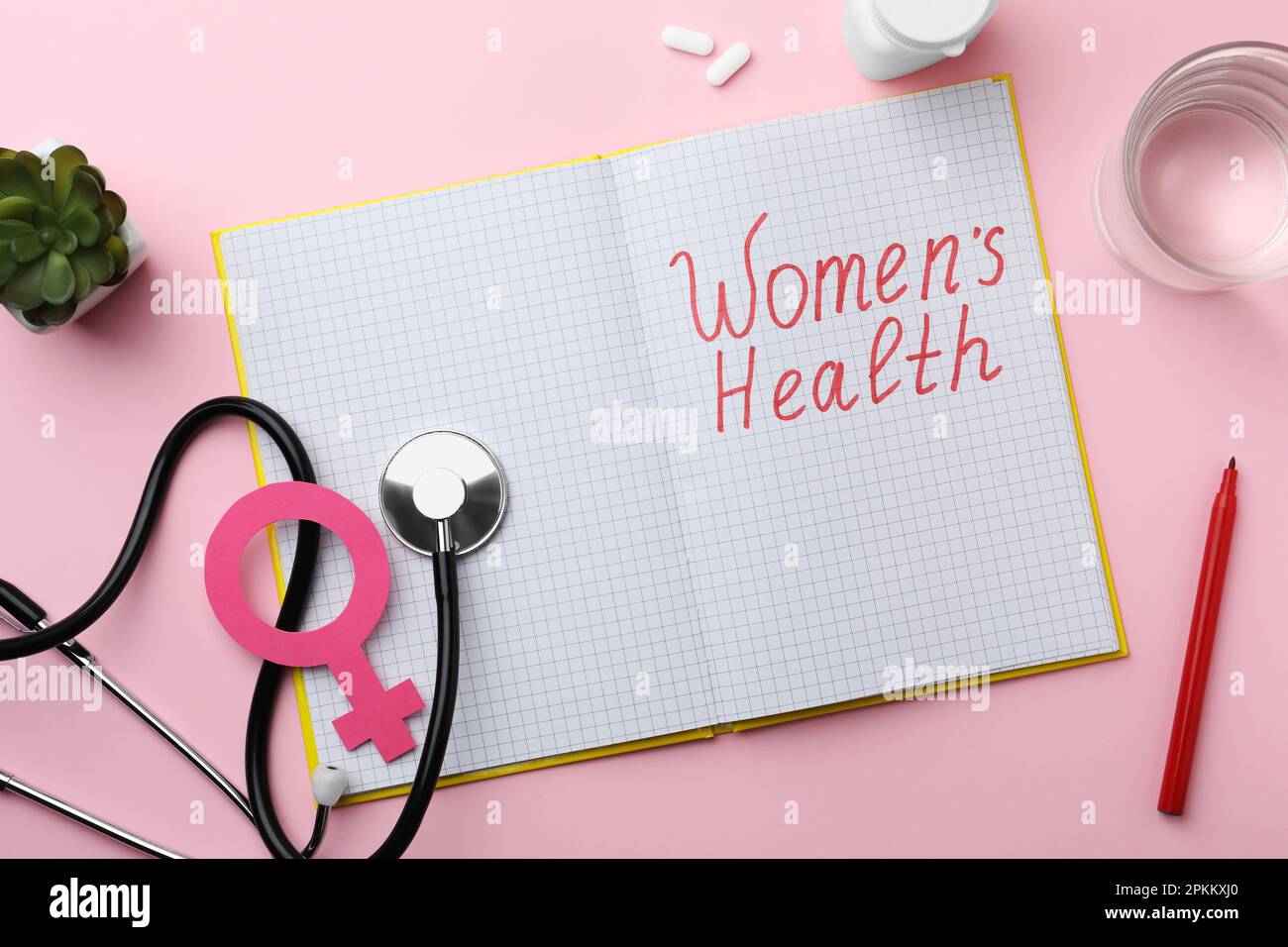Flat lay composition of notebook with words Women Health and female ...