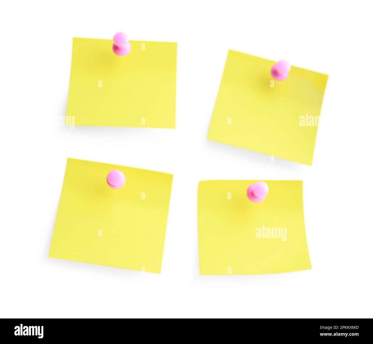 Blank pale yellow notes with pink pins on white background, top view ...