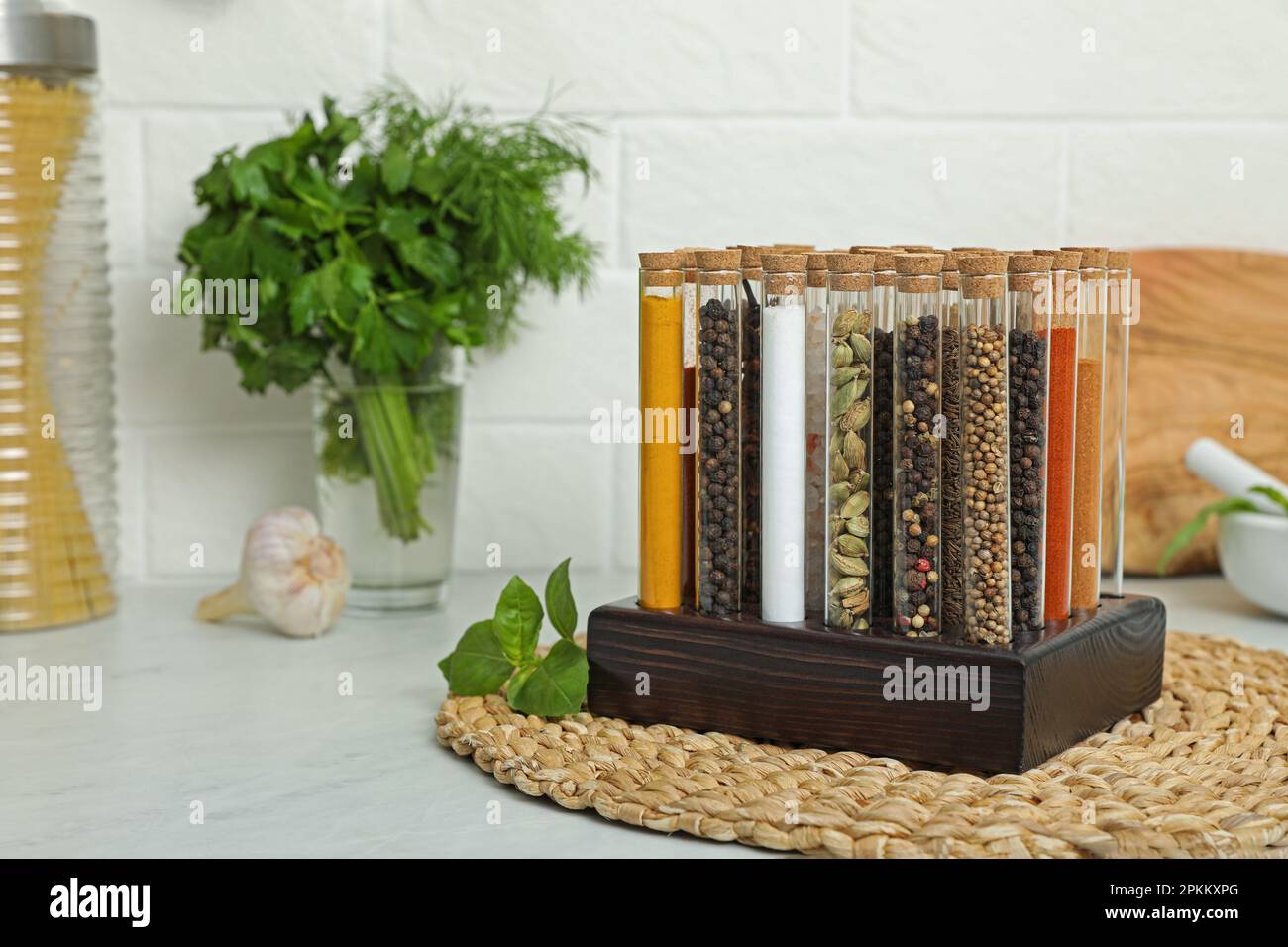 Glass tubes with different spices on kitchen counter Stock Photo - Alamy