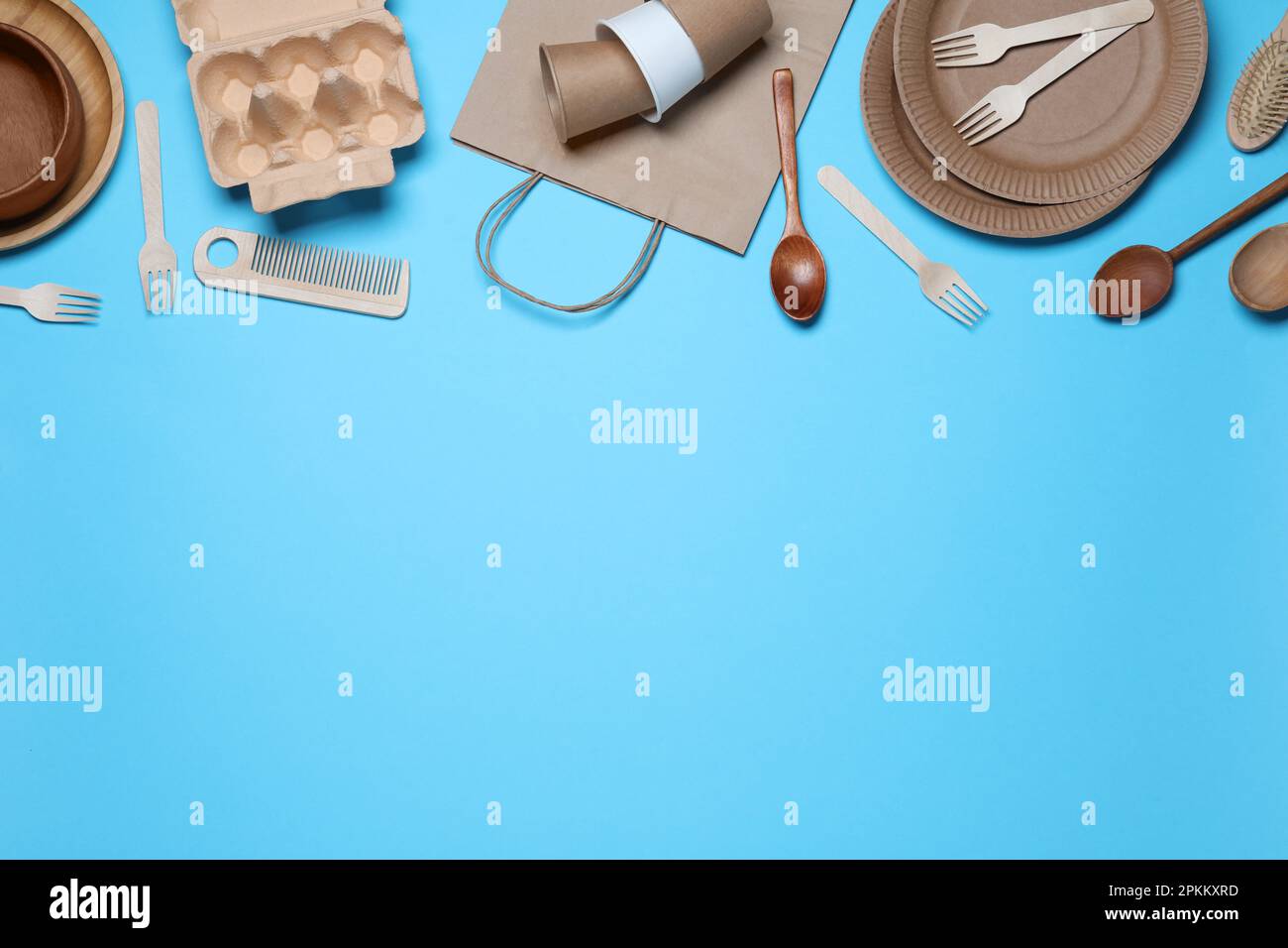 Different eco items on light blue background, flat lay with space for ...