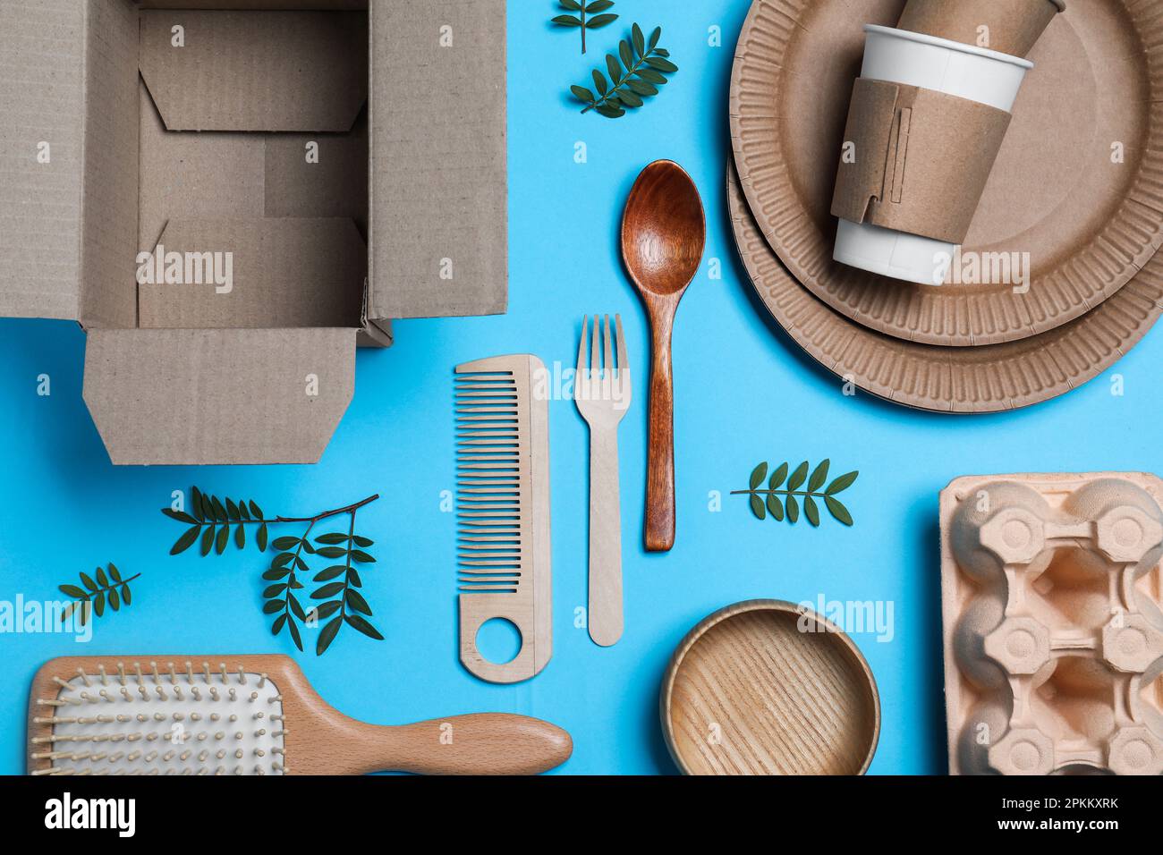 Different eco items on light blue background, flat lay. Recycling ...