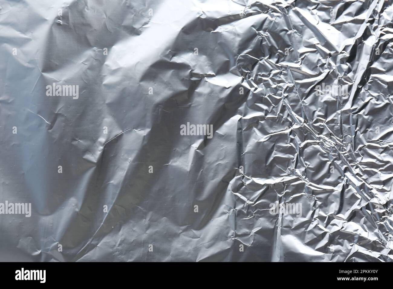 Crumpled silver foil as background, closeup view Stock Photo - Alamy