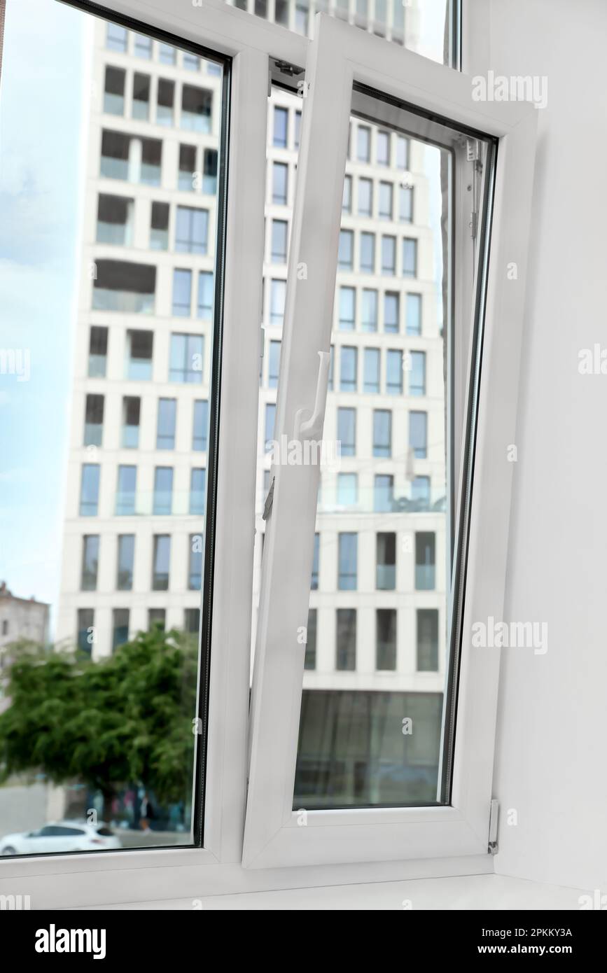 Open window with white plastic frame indoors Stock Photo - Alamy