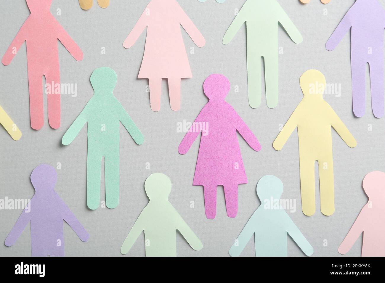 Many different paper human figures on grey background, flat lay ...