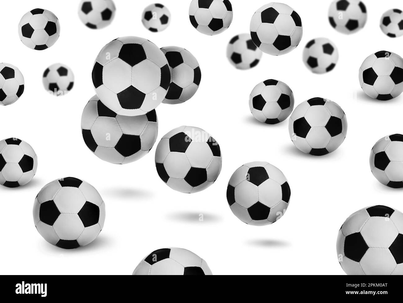 Falling new soccer balls on white background Stock Photo - Alamy