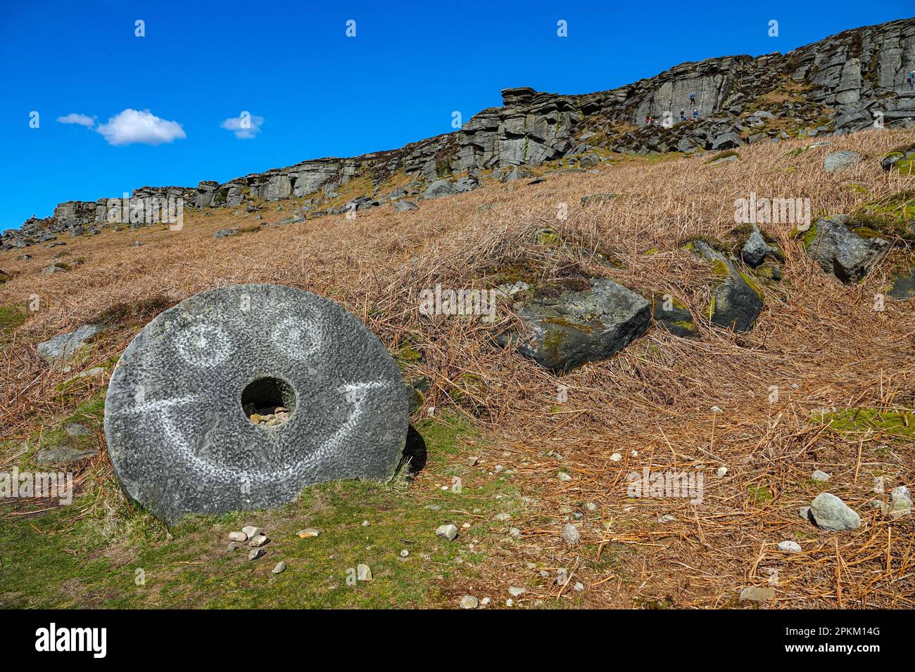 Smiley face scratched on Old abandoned millstones at Stanage Edge, a ...