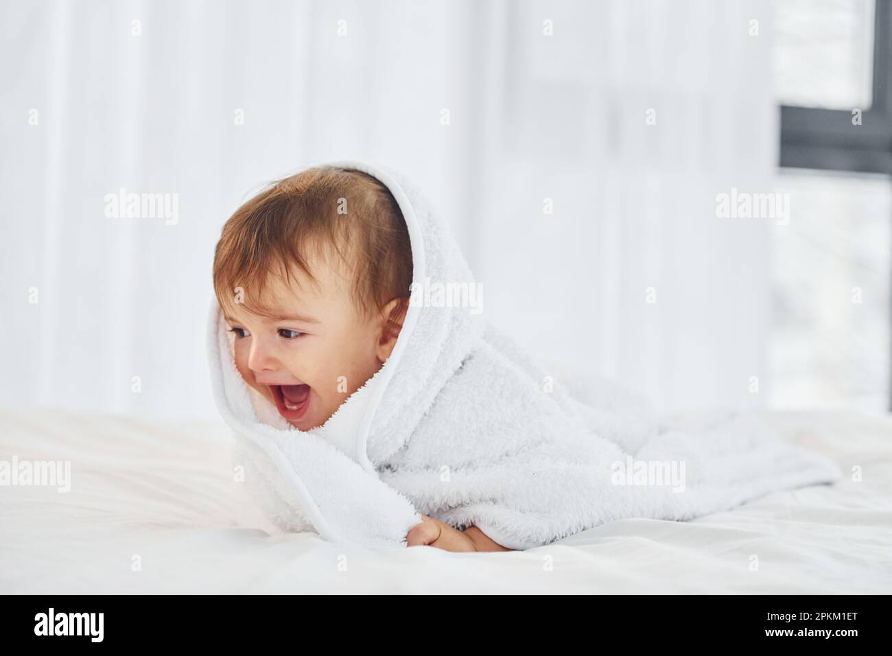 Positive emotions. Cute little baby is indoors in the domestic room ...