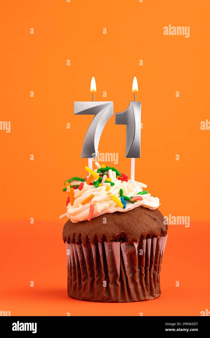 Candle number 71 - Cake birthday in orange background Stock Photo - Alamy