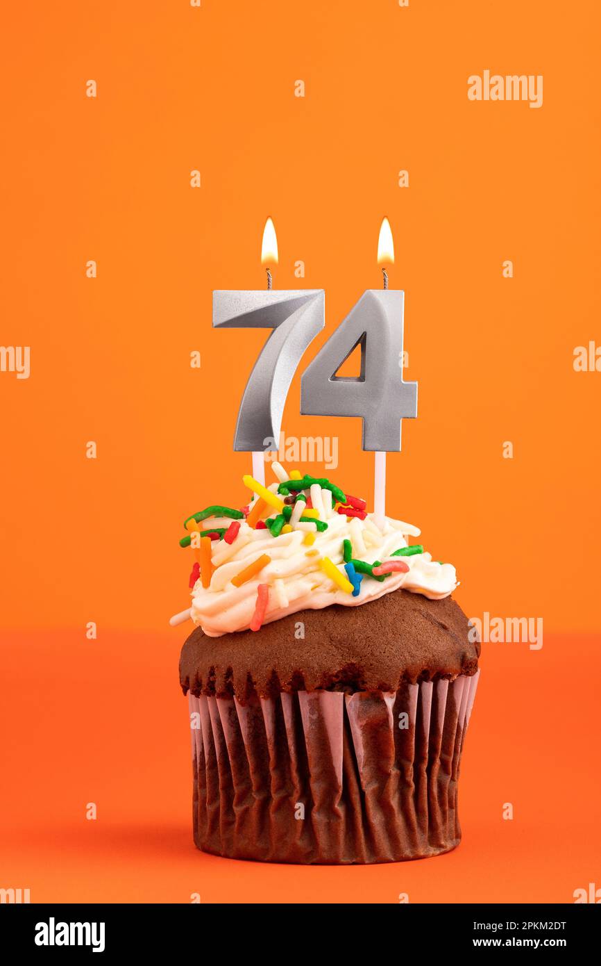 Birthday cake with candle number 74 - Orange foamy background Stock ...