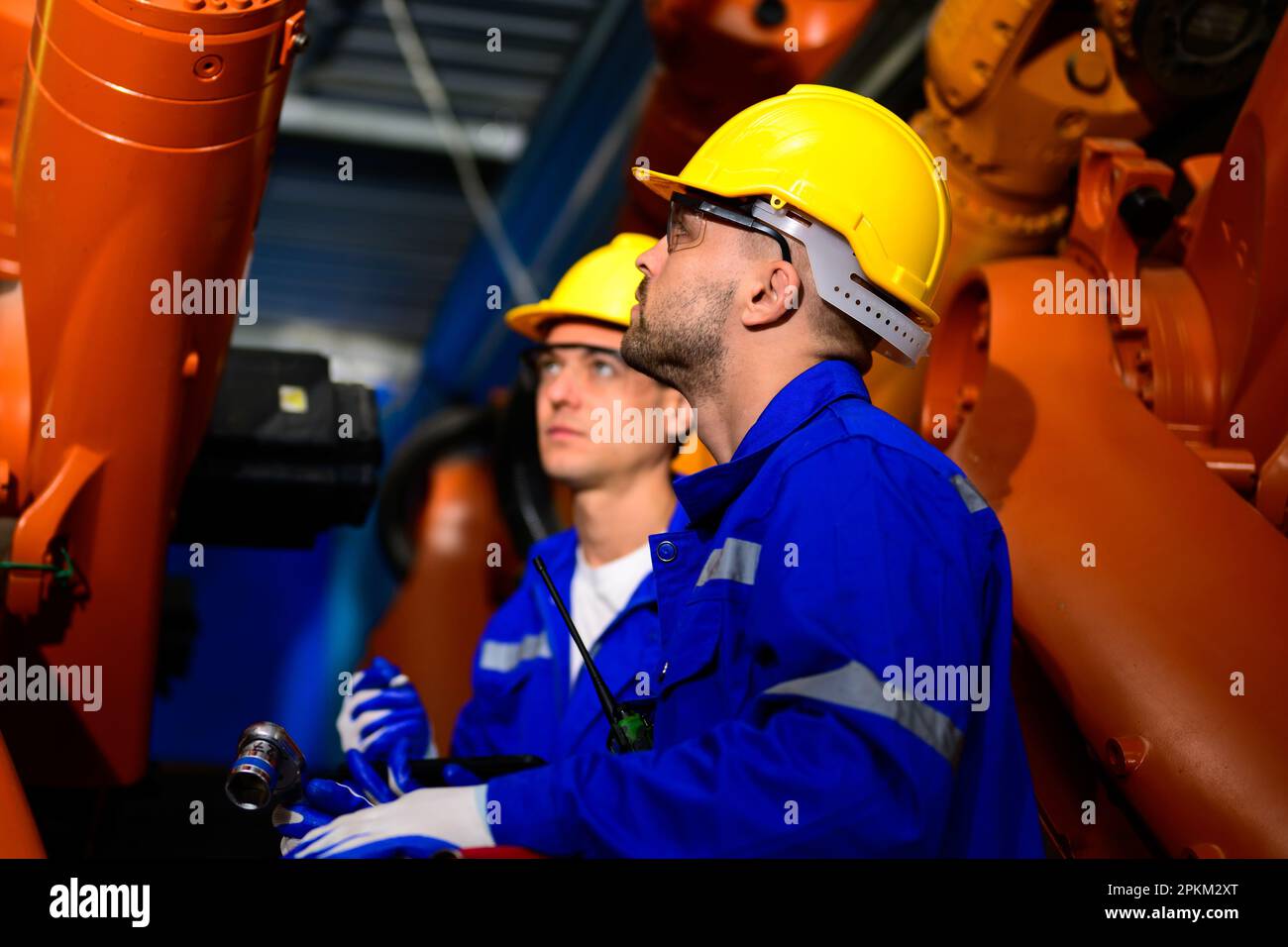 Technicians engineers team checking and maintaining safety of machine ...