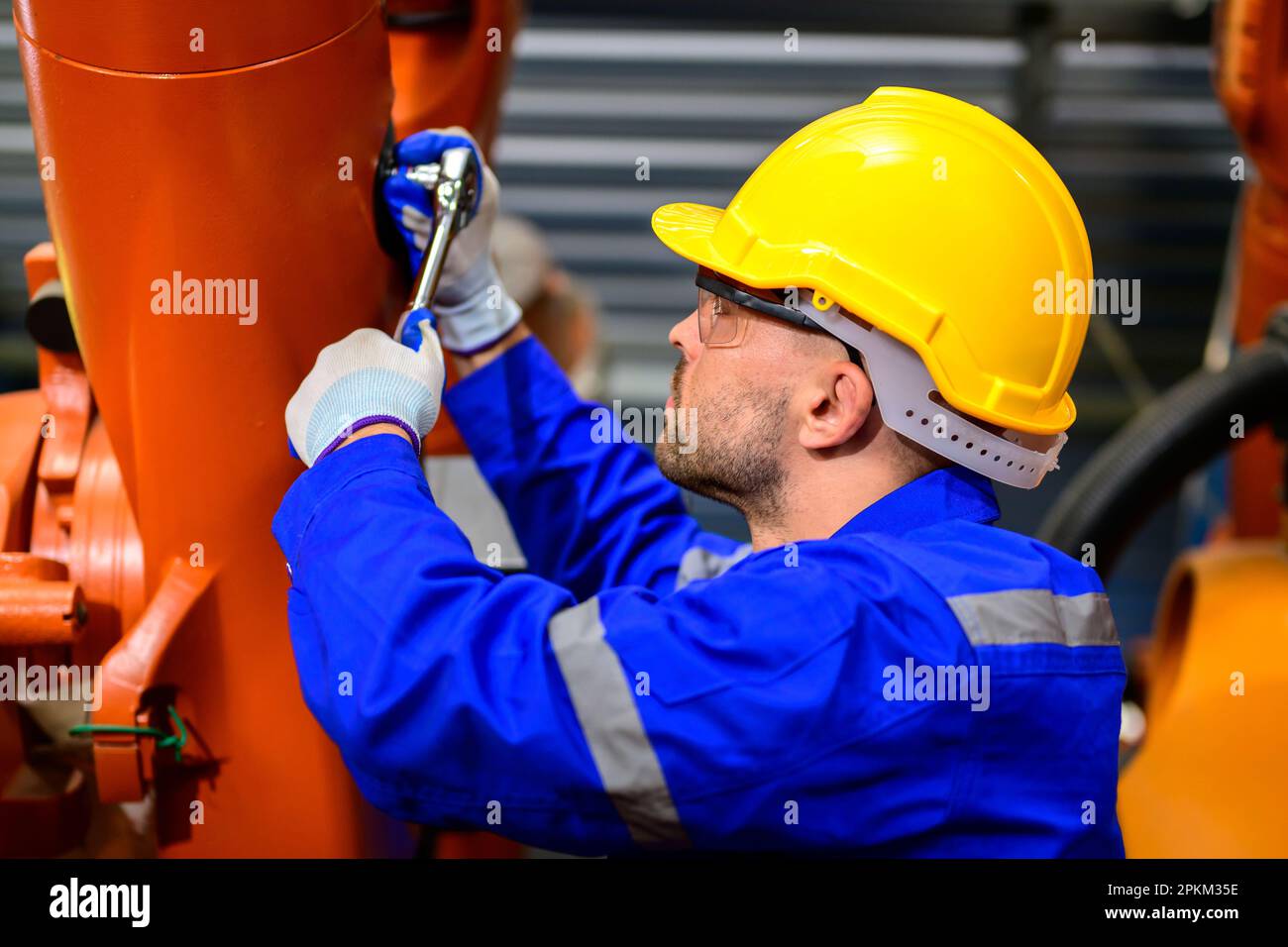 Portrait of professional male maintenance engineer working at factory ...