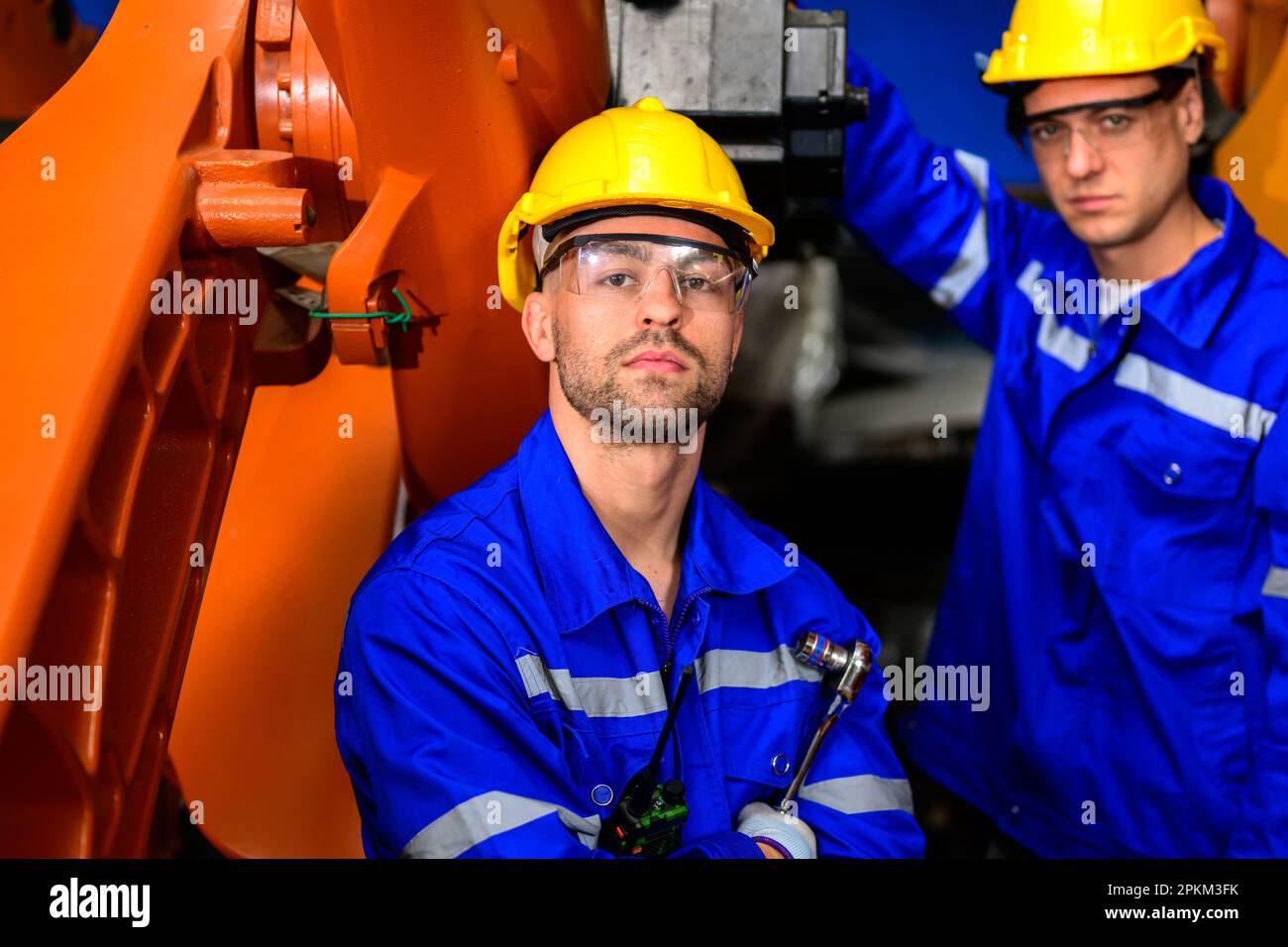 Portrait of professional male maintenance engineers working at factory Stock Photo - Alamy