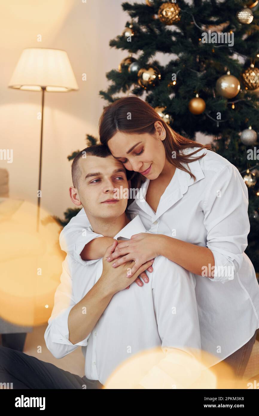 Embracing each other. Lovely couple celebrating holidays together ...