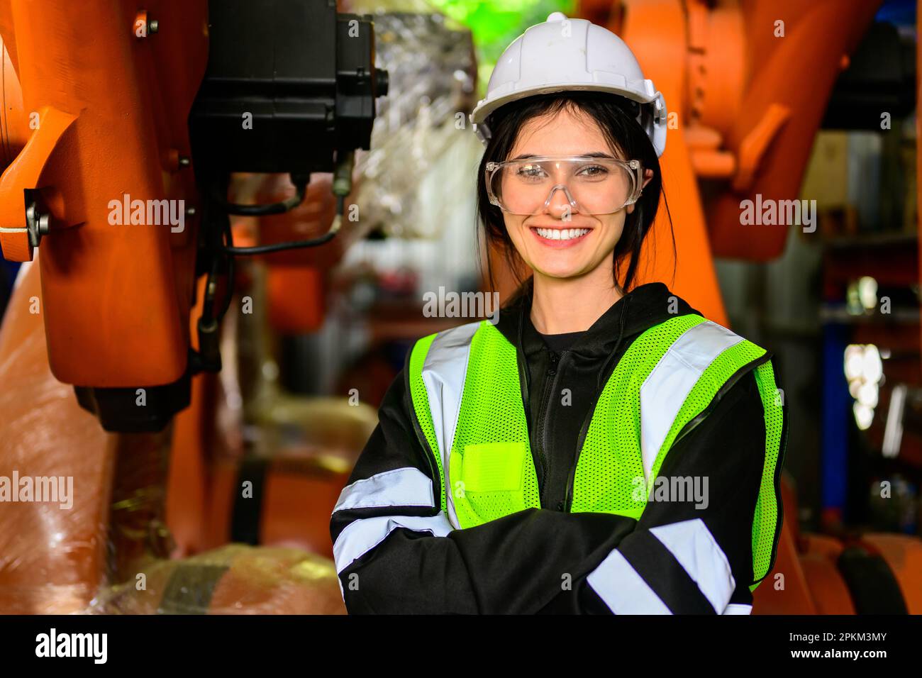 Happy female maintenance engineer worker working at industrial factory ...