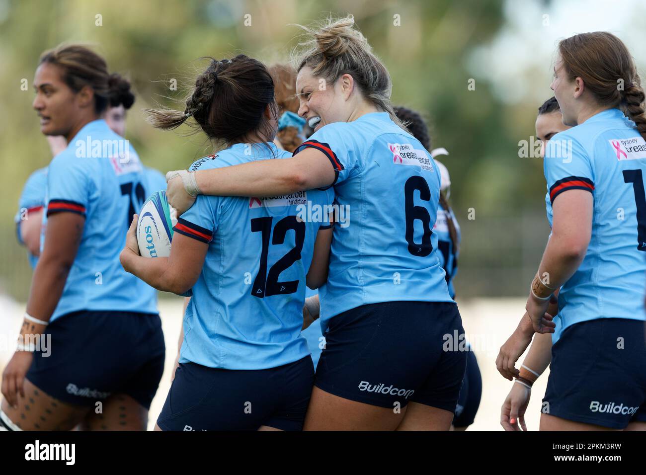 The Waratahs celebrate after scoring a try during the Buildcorp Super W match between the ...