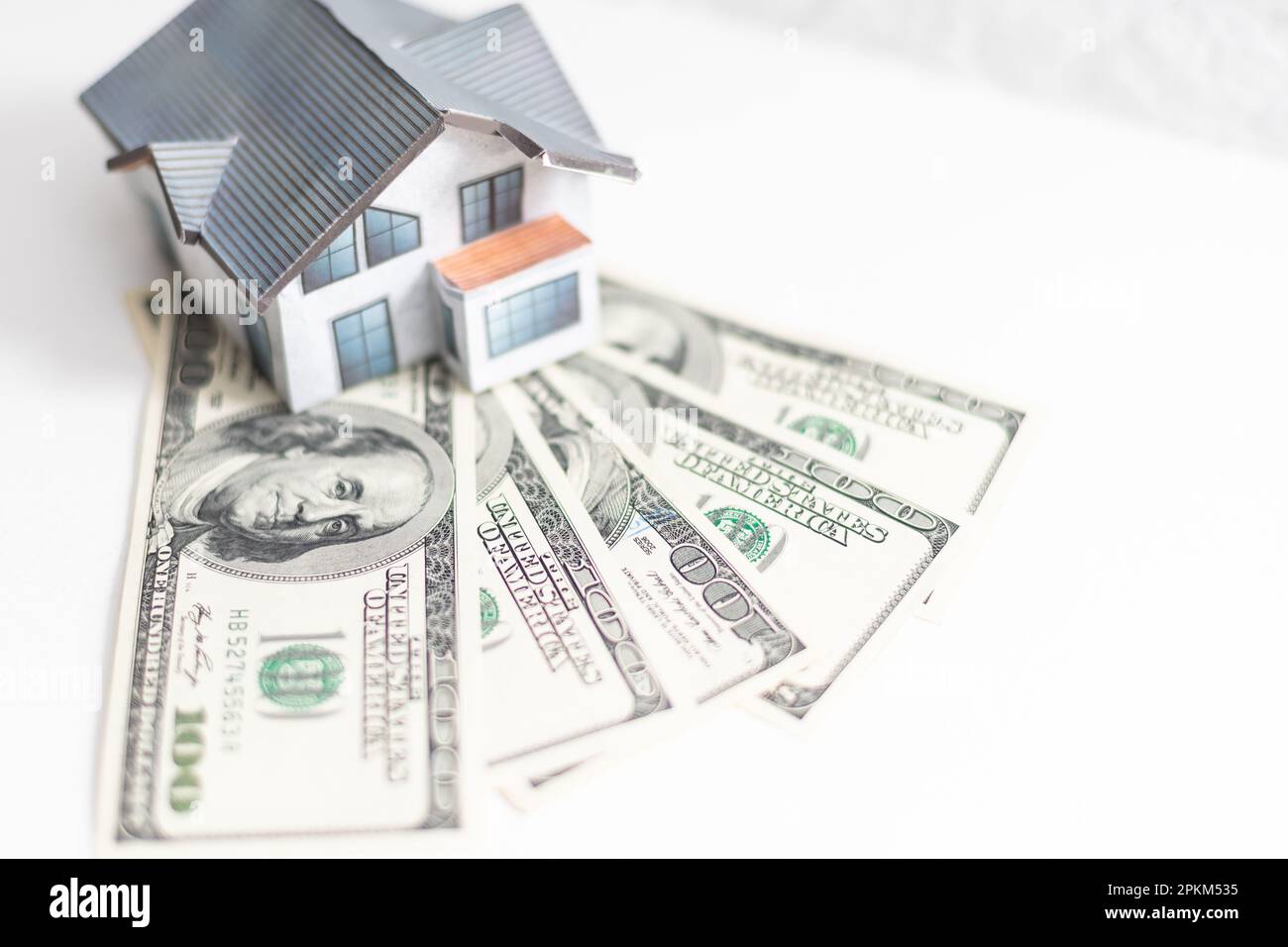 the layout of the house is on a pile of money Stock Photo - Alamy