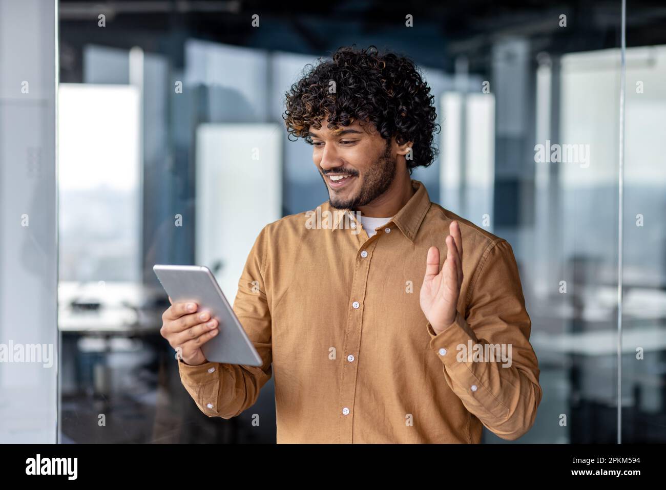 Successful hispanic man standing in office interior at workplace, man ...