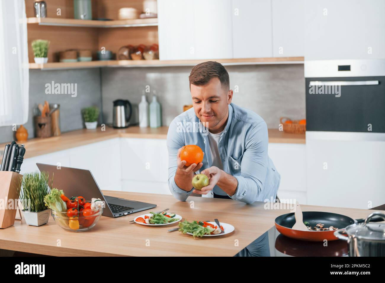 Man preparing food at home on the modern kitchen Stock Photo - Alamy