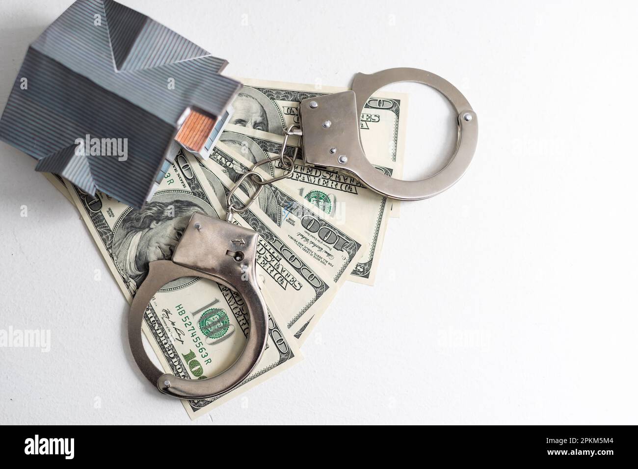 iron handcuffs, a house made of on a background of American dollar ...