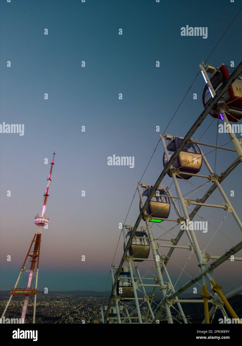 The Tbilisi TV Tower and Ferris wheel at Mtatsminda Park Stock Photo ...