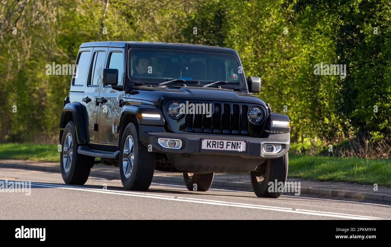 2019 black Wrangler Jeep car travelling on an English country road ...