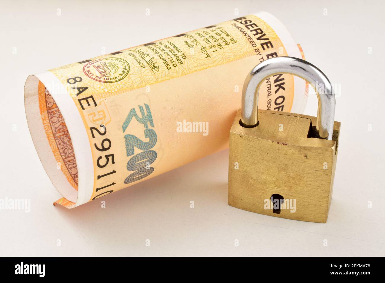 Indian currency money with lock on white background Stock Photo - Alamy