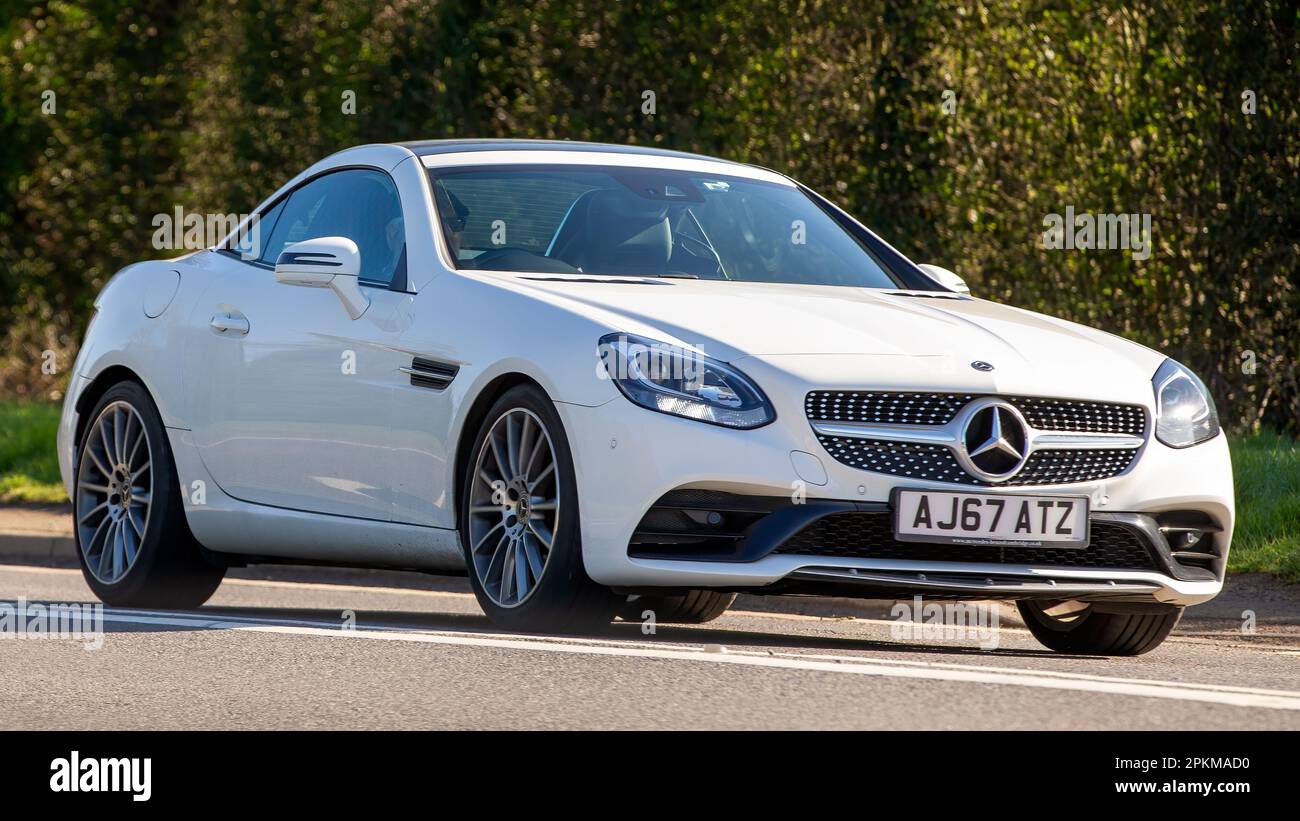 2018 white Mercedes Benz SLC car travelling on an English country road ...