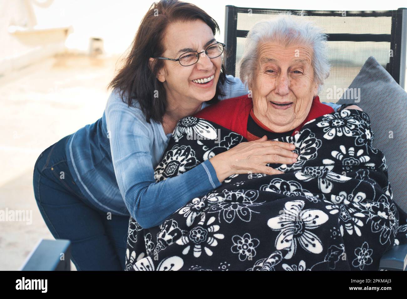 A middle-aged woman and a old woman having fun together and laughing Stock Photo - Alamy