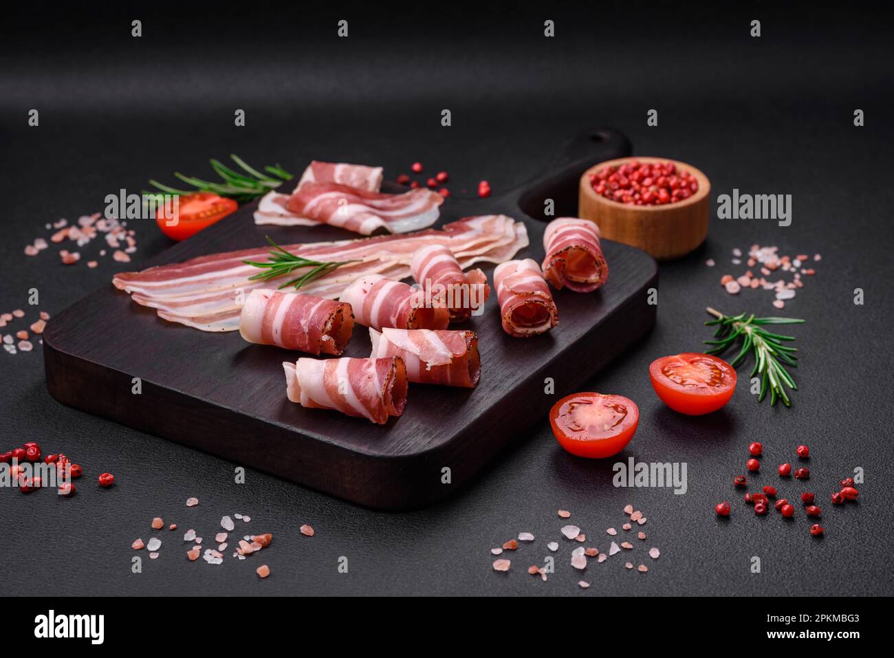 Delicious fresh pancetta with salt and spices cut into thin slices on a ...