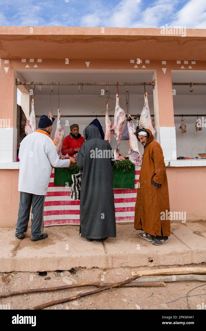 Moroccan men gather at a butcher stand in a berber market Stock Photo ...