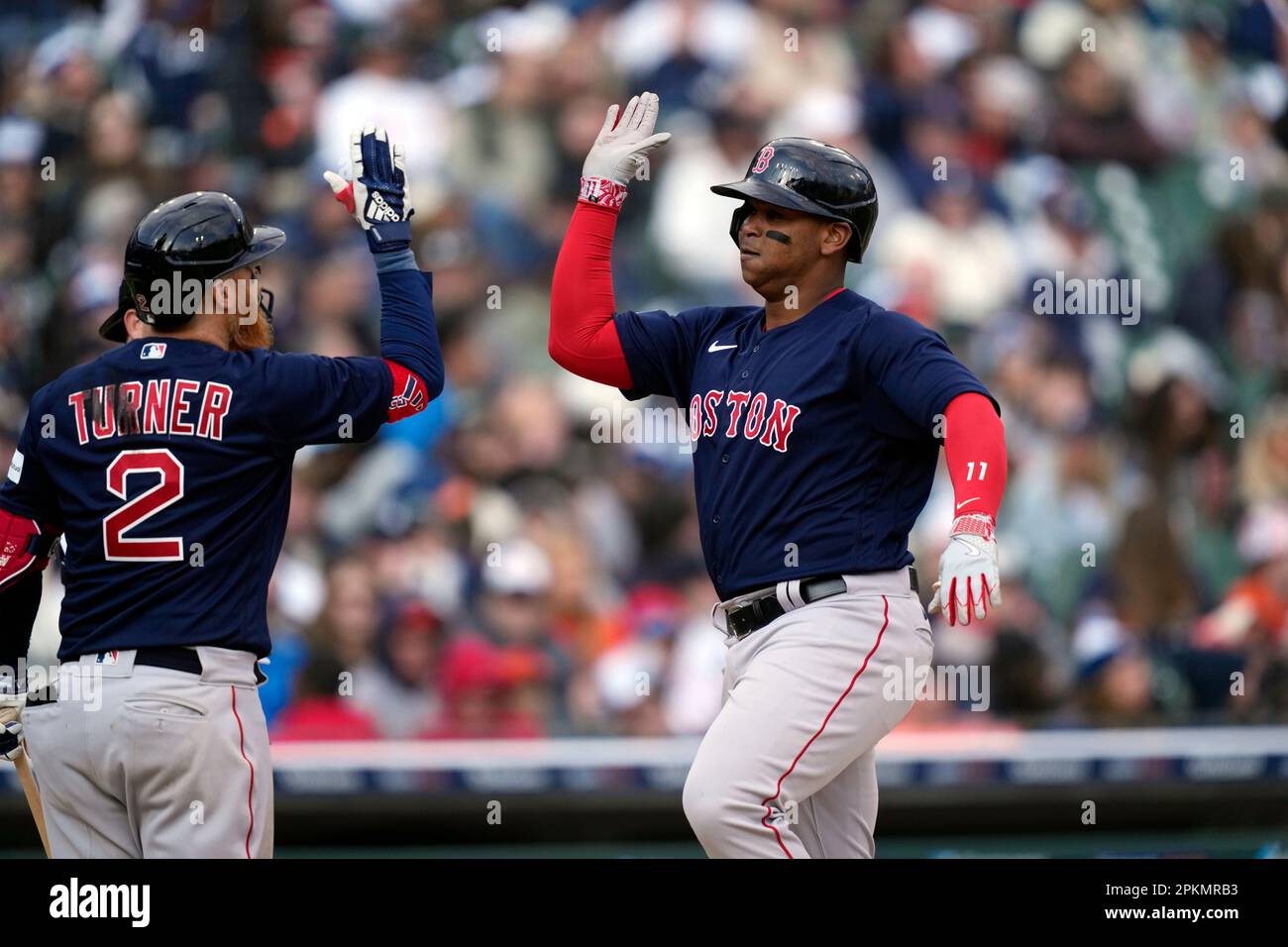 Boston Red Sox's Rafael Devers is greeted by Justin Turner (2) after a ...