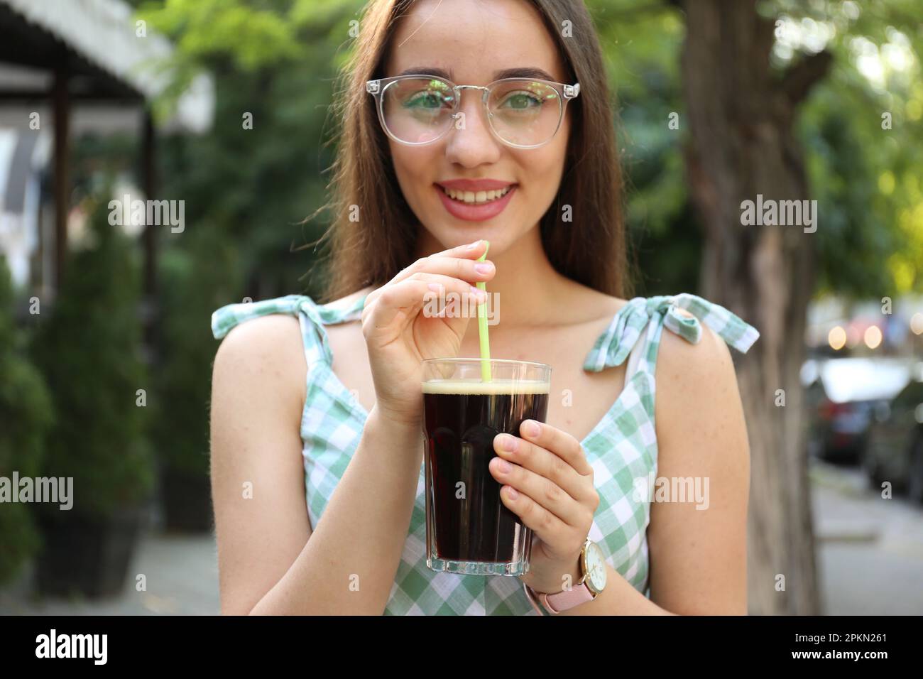 Young woman with cold kvass outdoors. Traditional Russian summer drink ...