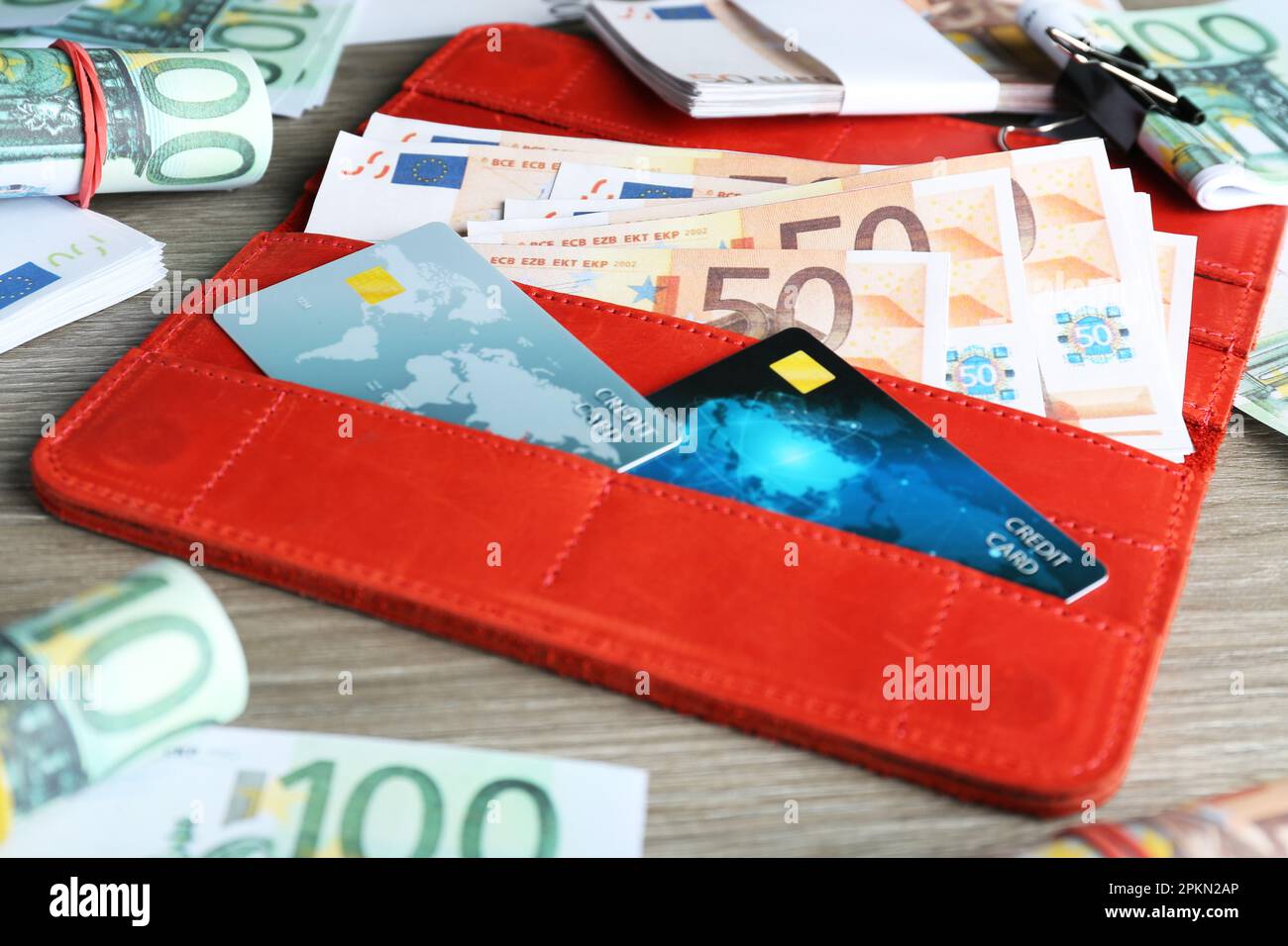 Wallet with different Euro banknotes and credit cards on wooden table ...