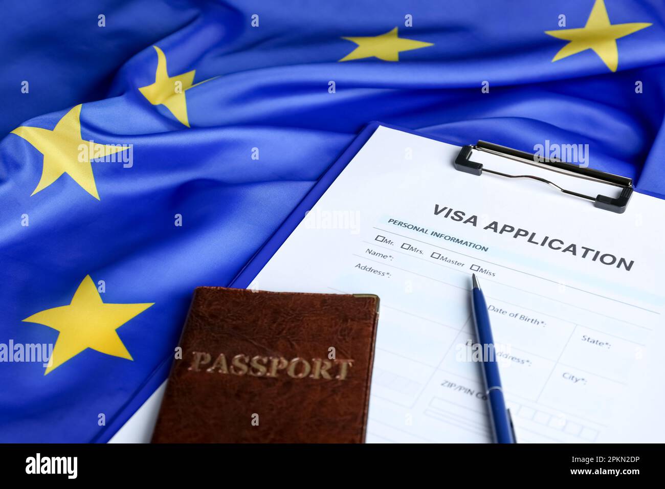 Visa application form for immigration, passport and pen on European ...