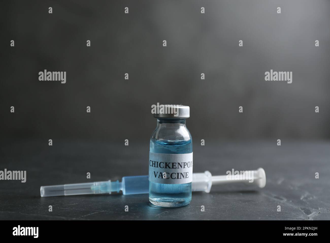 Chickenpox vaccine and syringe on grey background. Varicella virus ...