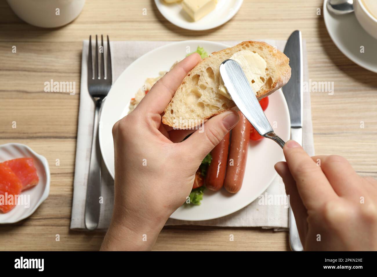 Woman spreading butter on toast at table, closeup. Buffet service Stock ...