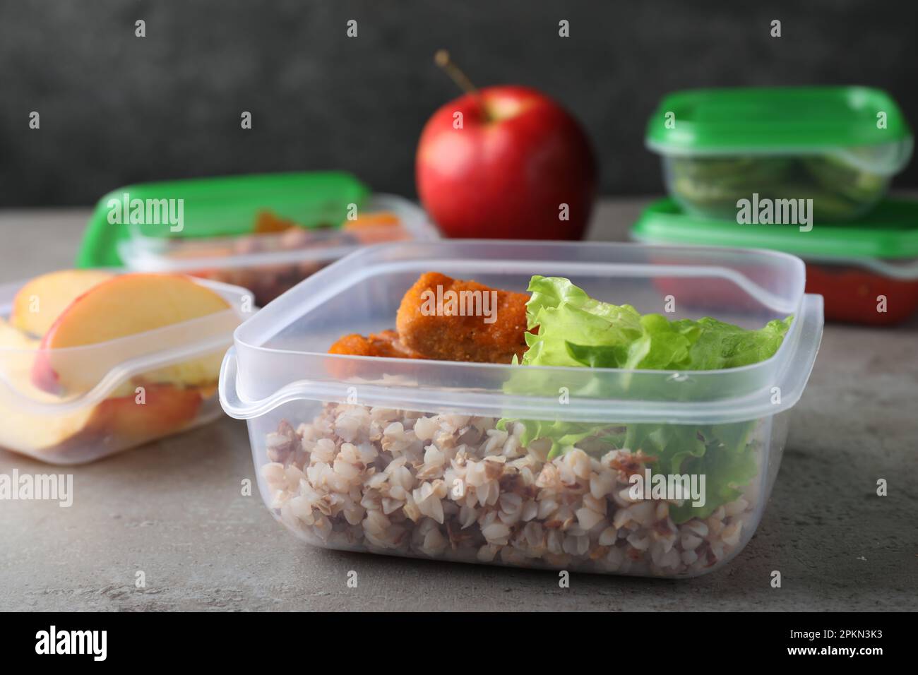 Set of plastic containers with fresh food on light grey table Stock ...