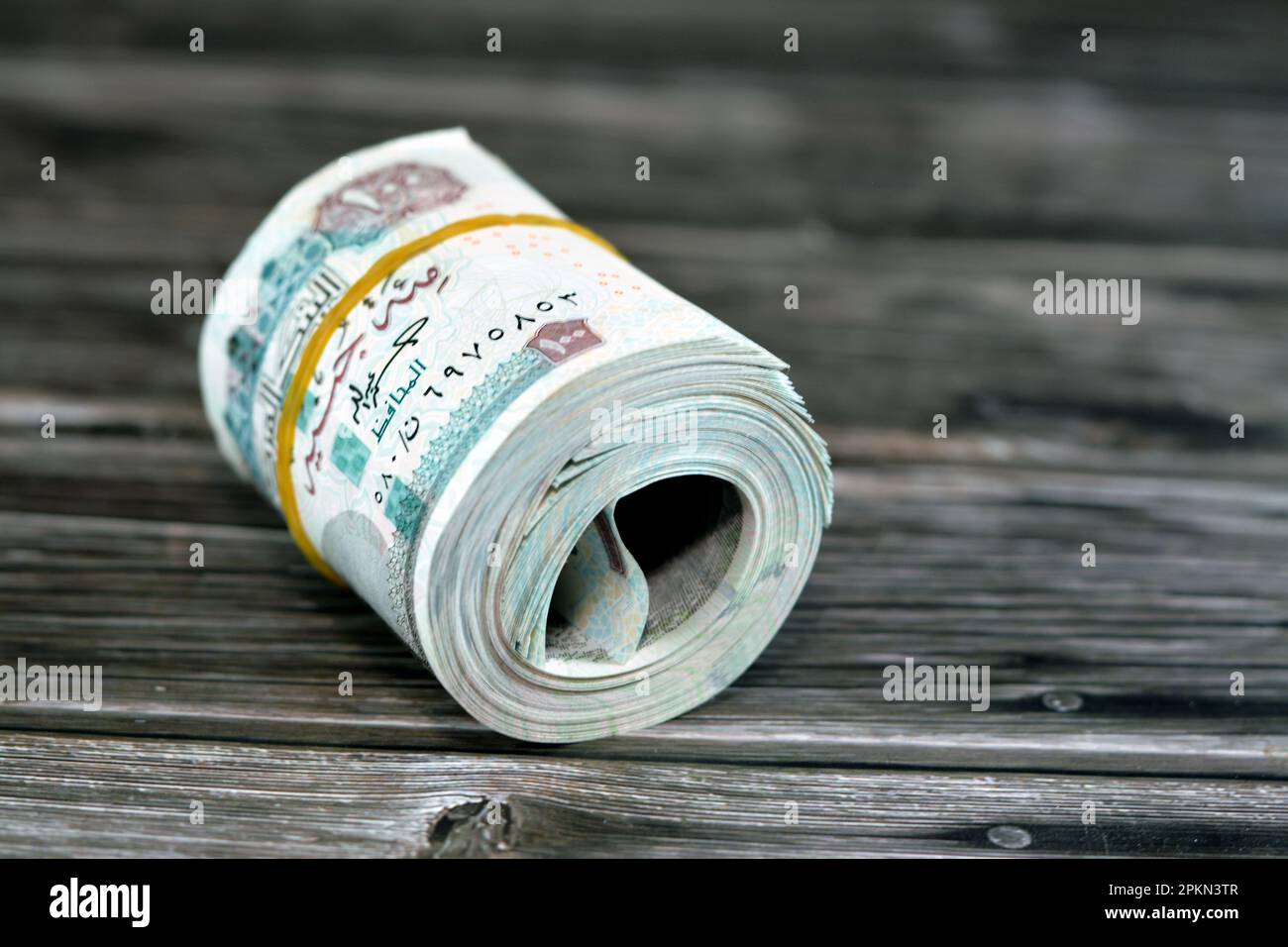 100 EGP LE one hundred Egyptian pounds cash money bills rolled up with ...