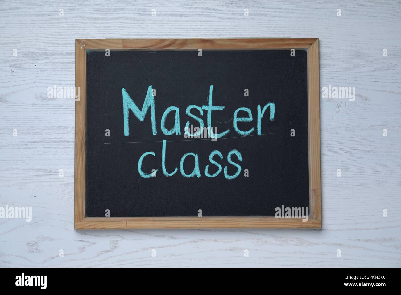 Blackboard with phrase Master class on white wooden table, top view ...