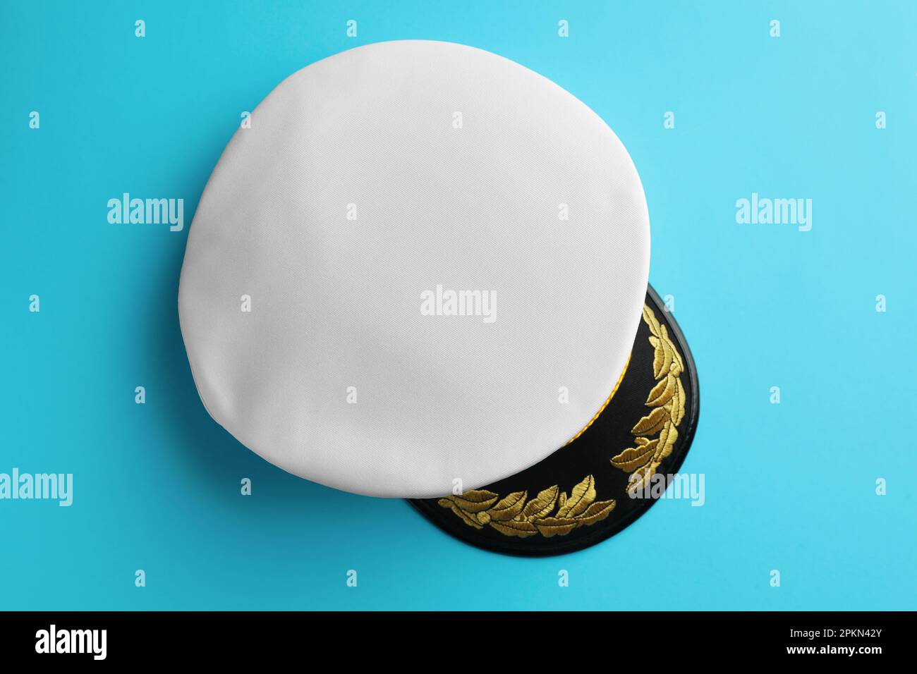 Peaked cap with accessories on light blue background, top view Stock ...