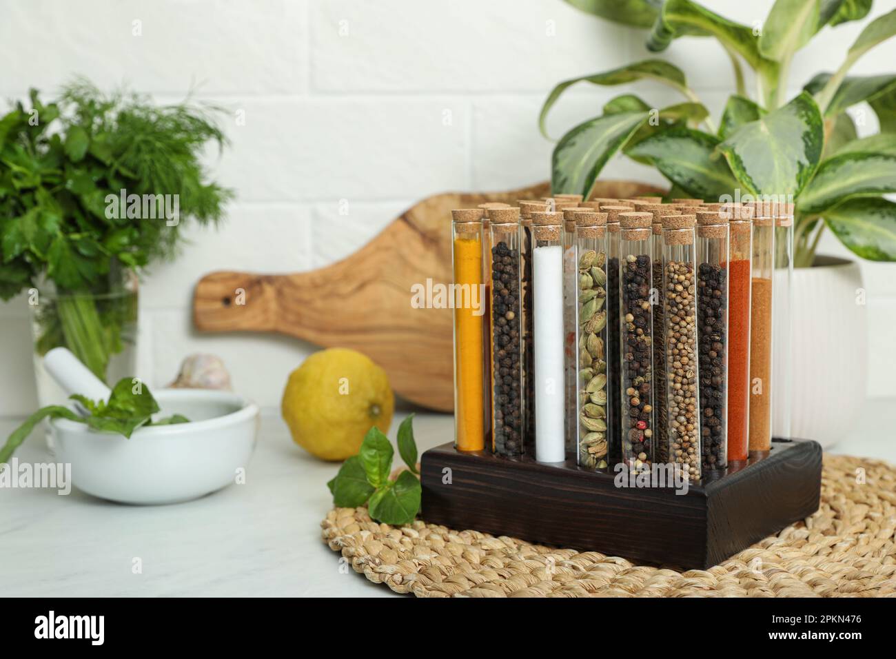 Glass tubes with different spices on kitchen counter Stock Photo - Alamy