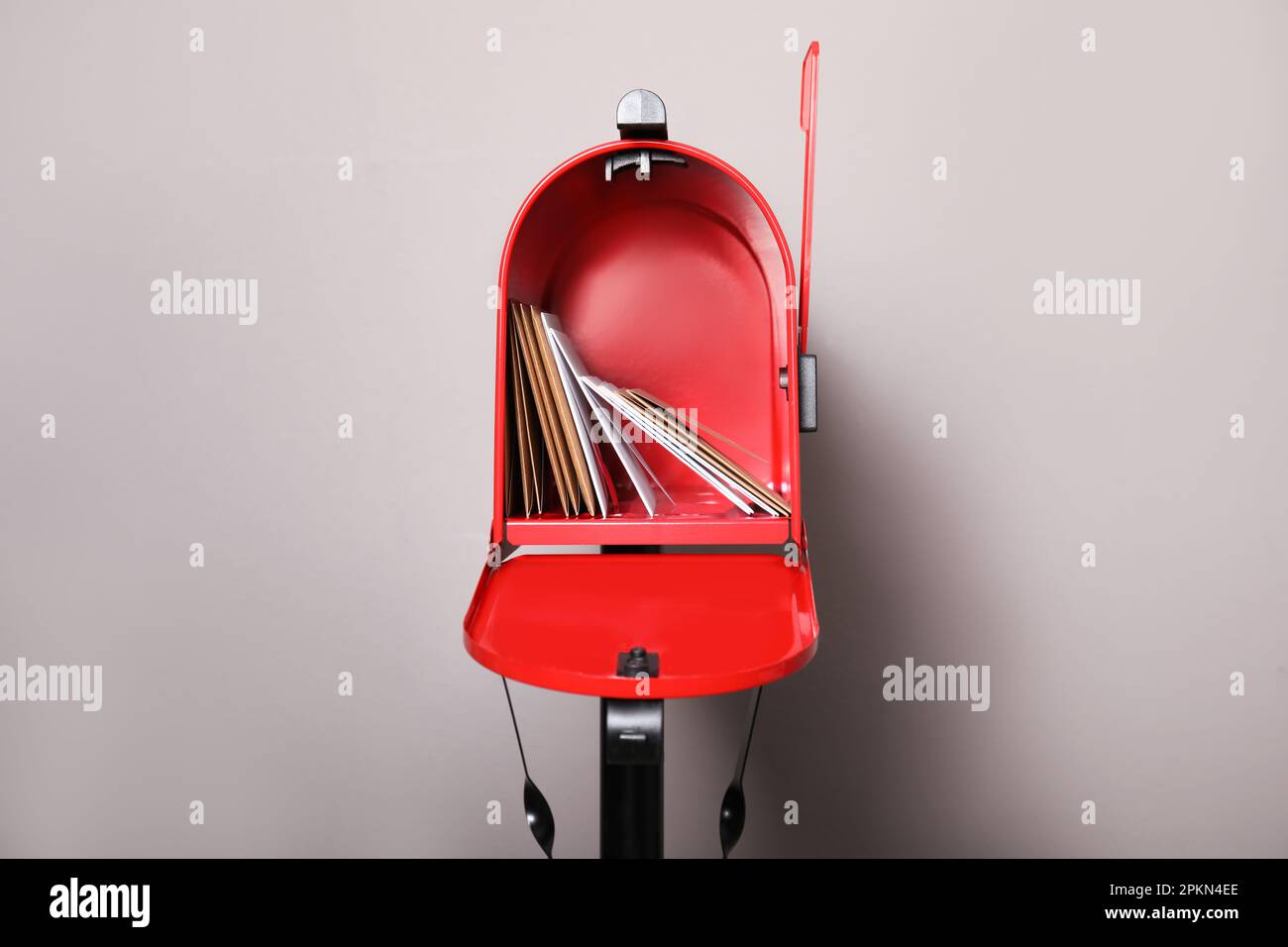 Open red letter box with envelopes against grey background Stock Photo ...