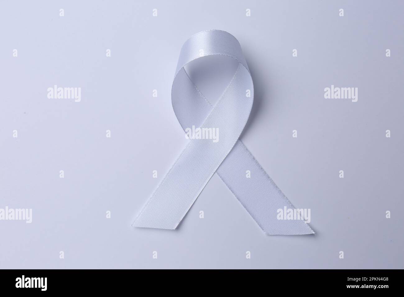 White awareness ribbon on white background, top view Stock Photo - Alamy