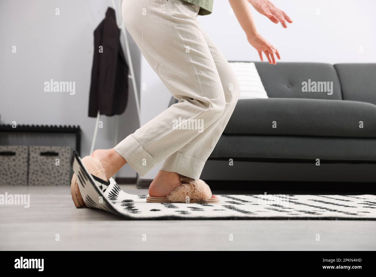 Woman tripping over carpet at home, closeup Stock Photo - Alamy