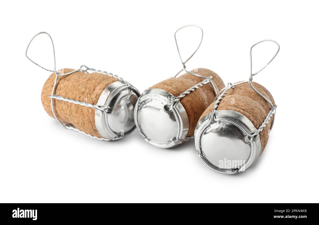 Sparkling wine corks with muselet caps on white background Stock Photo ...