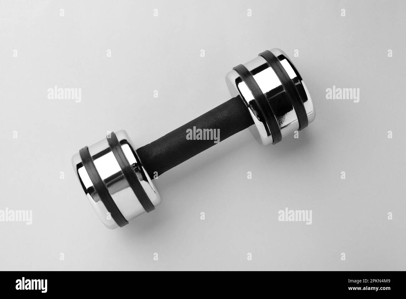 Metal dumbbell on light background, top view Stock Photo - Alamy